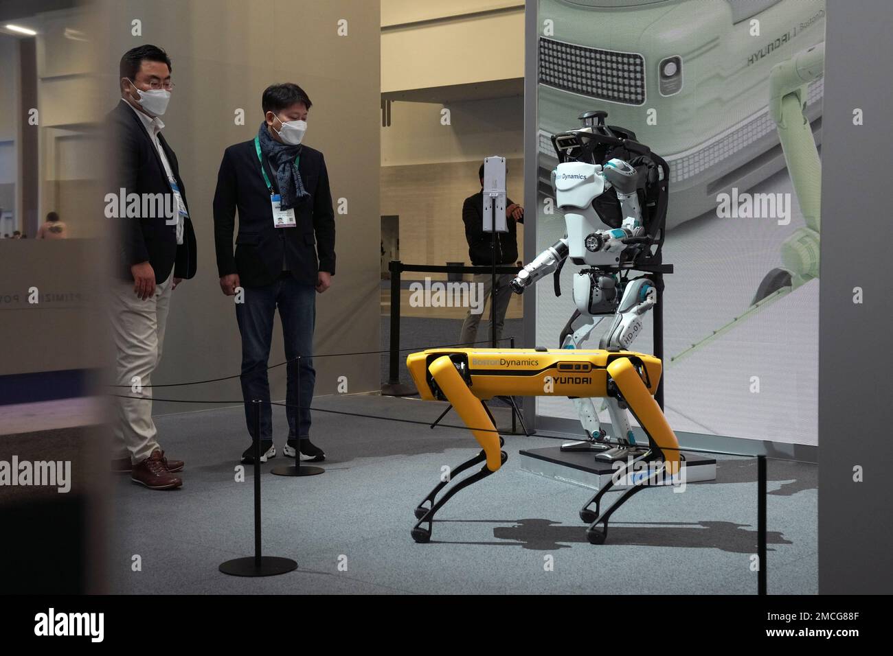 People view the Boston Dynamics robots Spot, front, and Atlas, rear, at ...