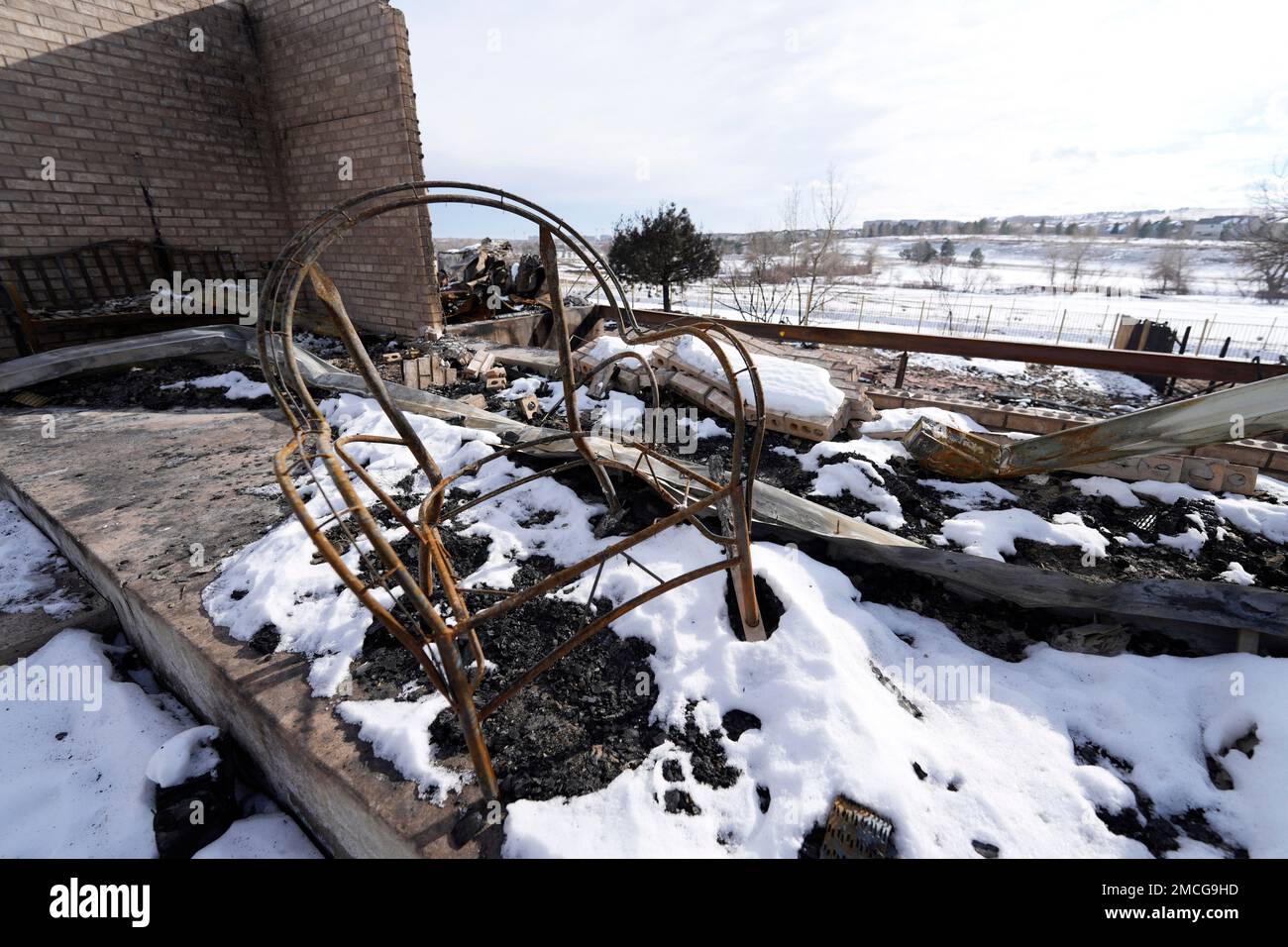 The frame of a torched chair sits amid the rubble of a home destroyed ...