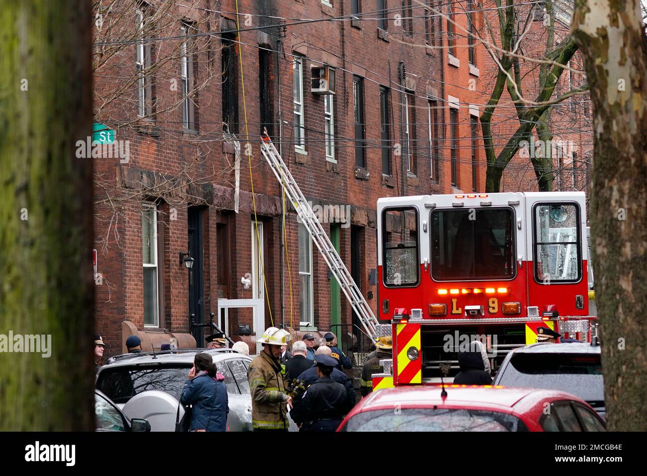 Philadelphia firefighters work at the scene of a deadly row house fire ...