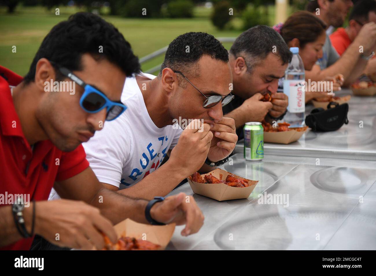 Keesler personnel participates in a hot wings eating contest during ...