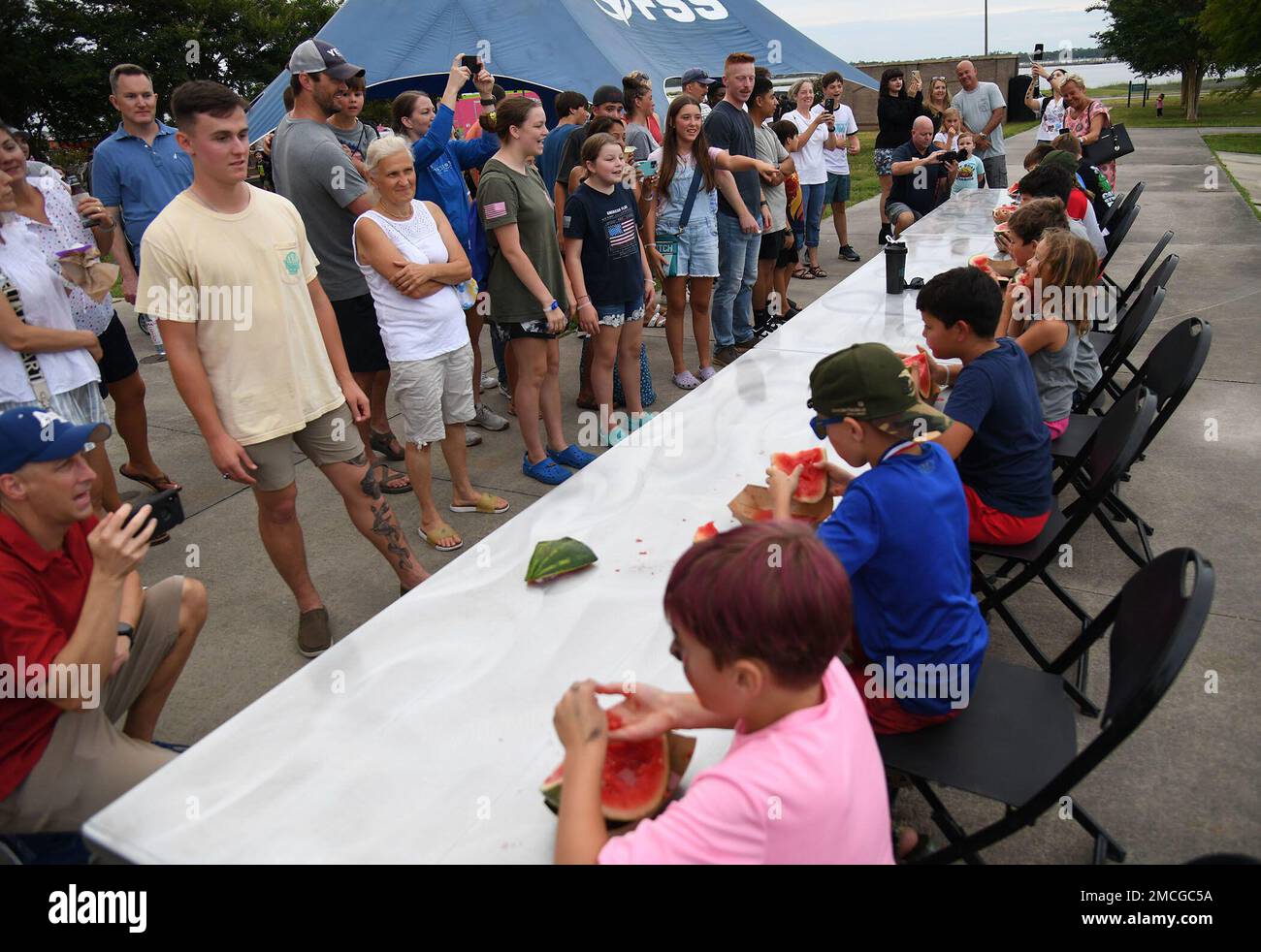 Keesler personnel and families gather to watch a watermelon eating ...