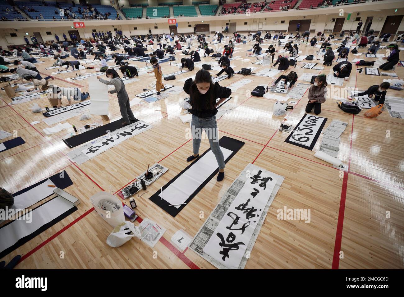 Participants perform traditional Japanese calligraphy during the annual ...