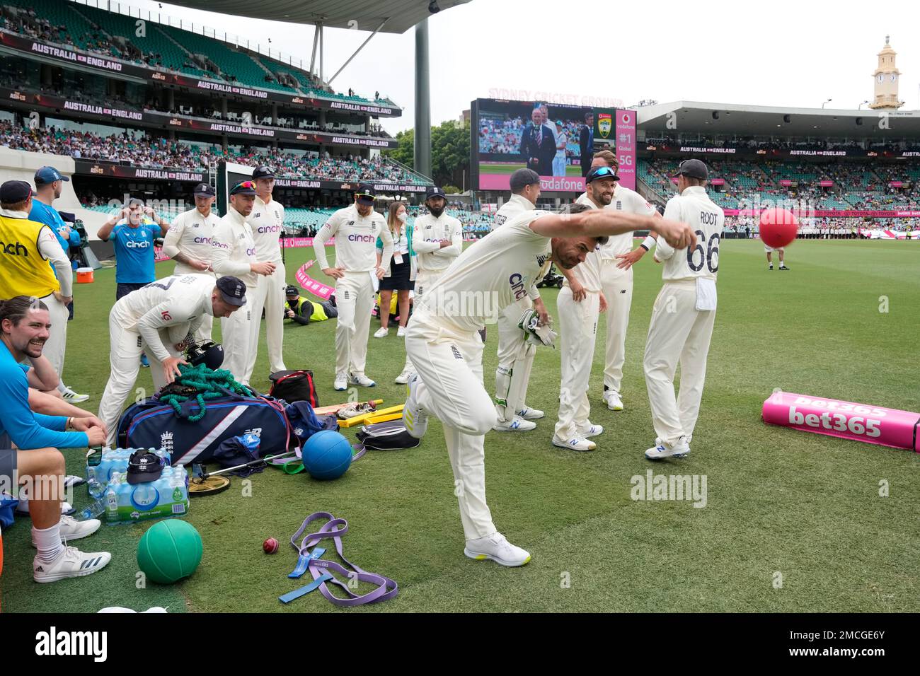 England's James Anderson, center, warms up before taking the field ...