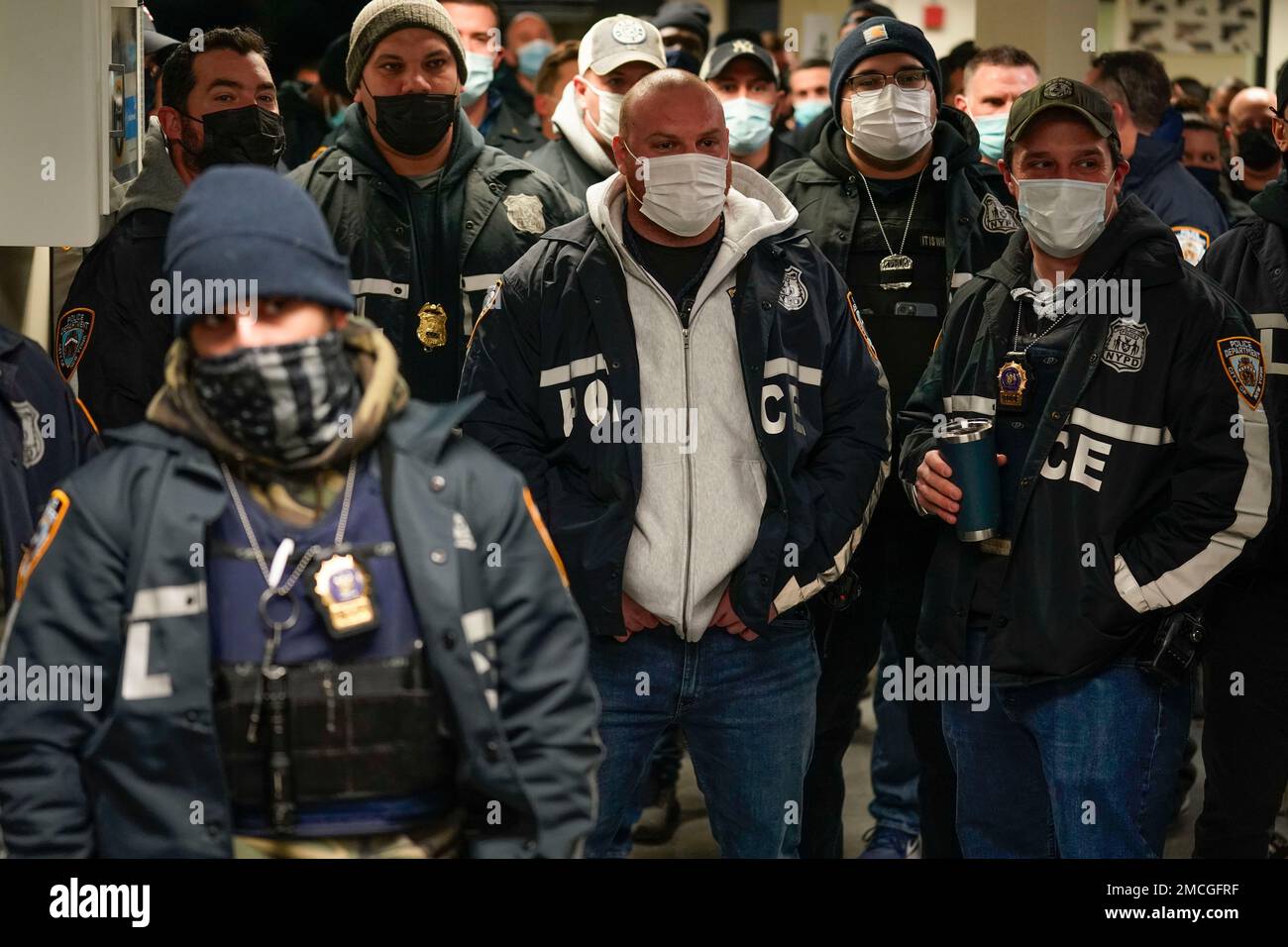 Police officers listen to a briefing before a raid in the Brooklyn ...