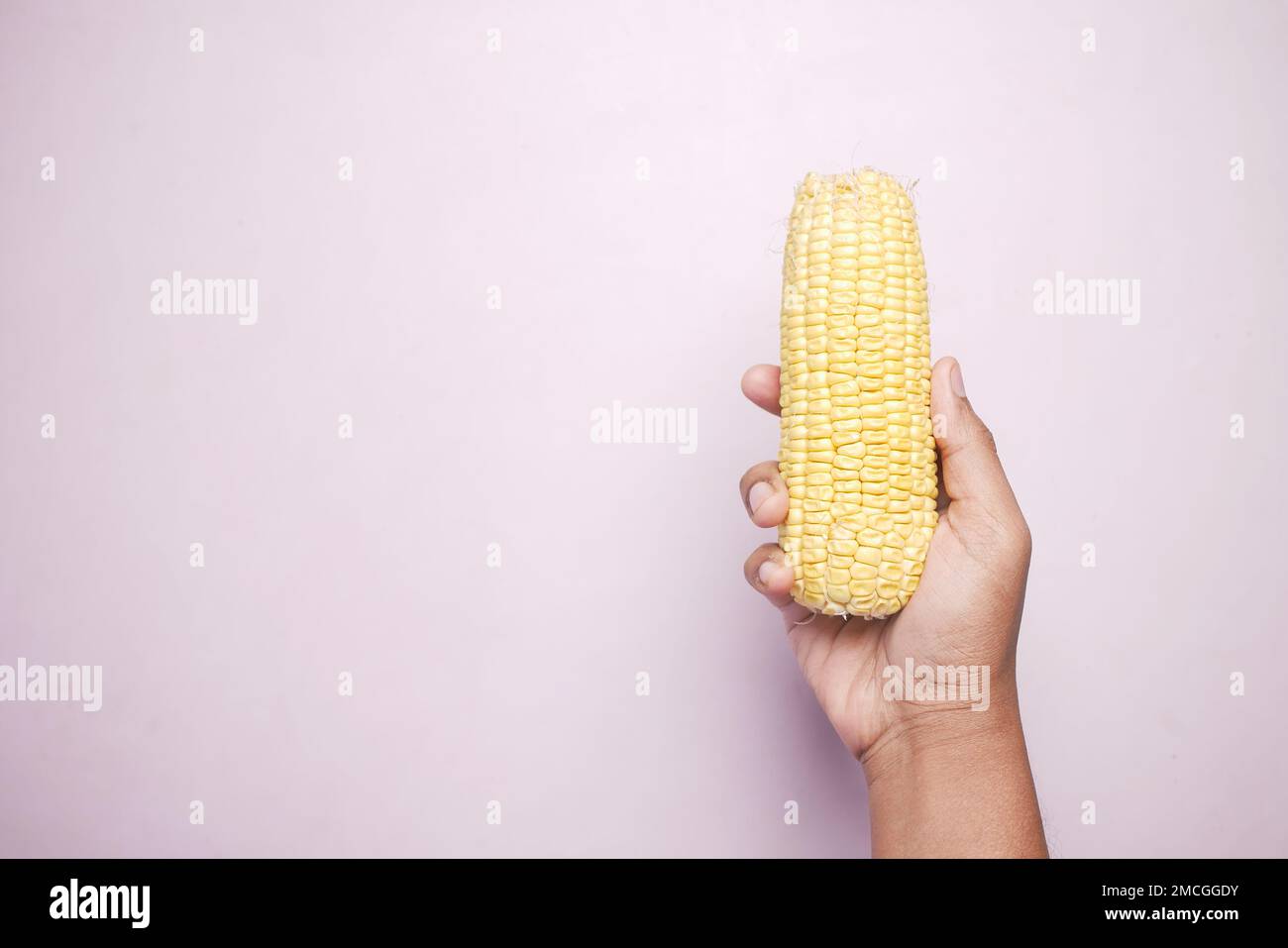 men holding a corn cob on white background Stock Photo - Alamy