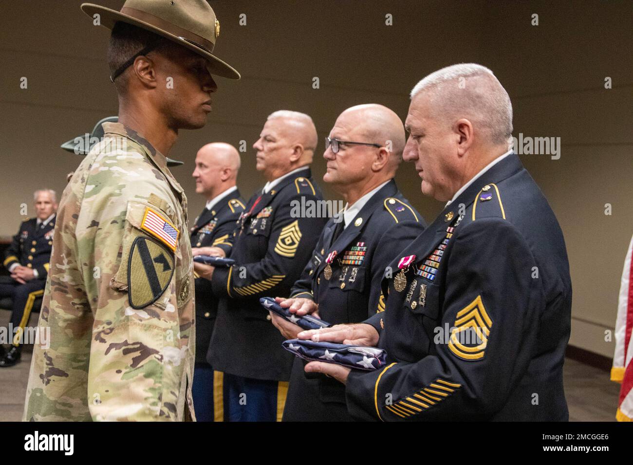 Army Reserve drill sergeant Staff Sgt. Jeffrey Ousley, left, presents the American flag to ...