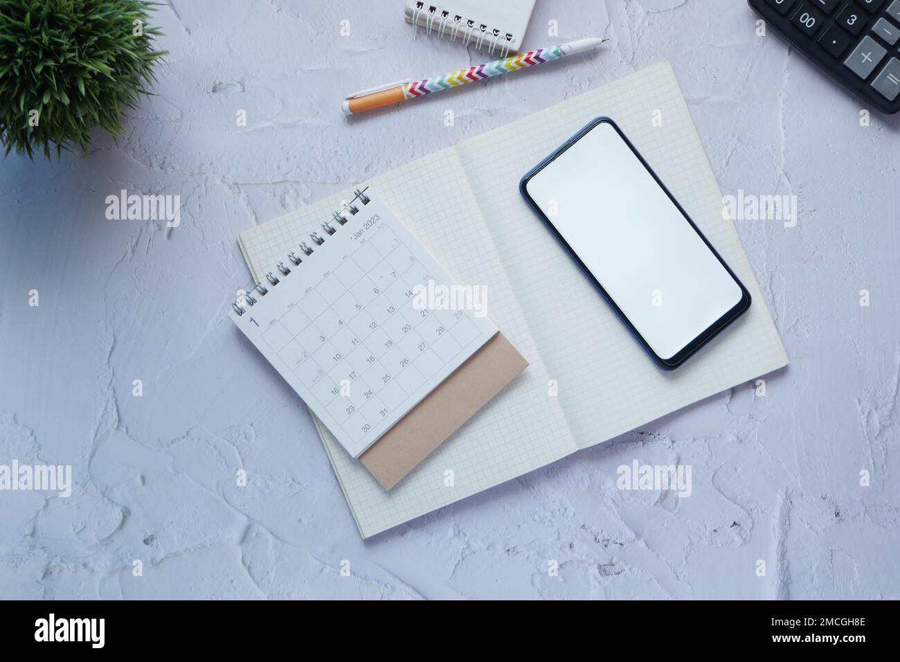 top view of calendar and smart phone with white screen on table Stock ...