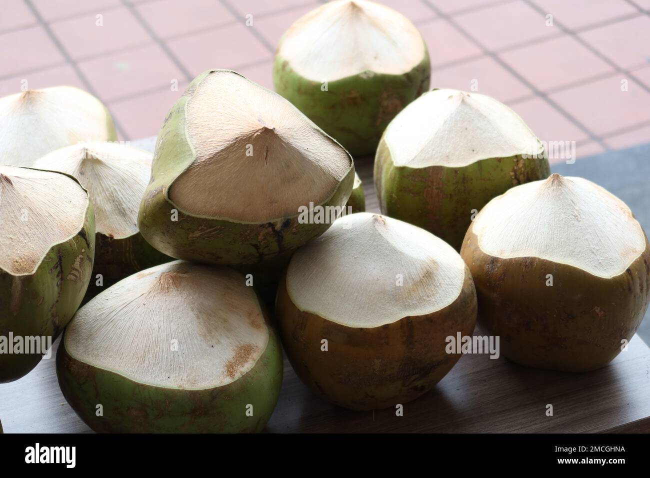 stack of fresh coconut display for sale Stock Photo - Alamy
