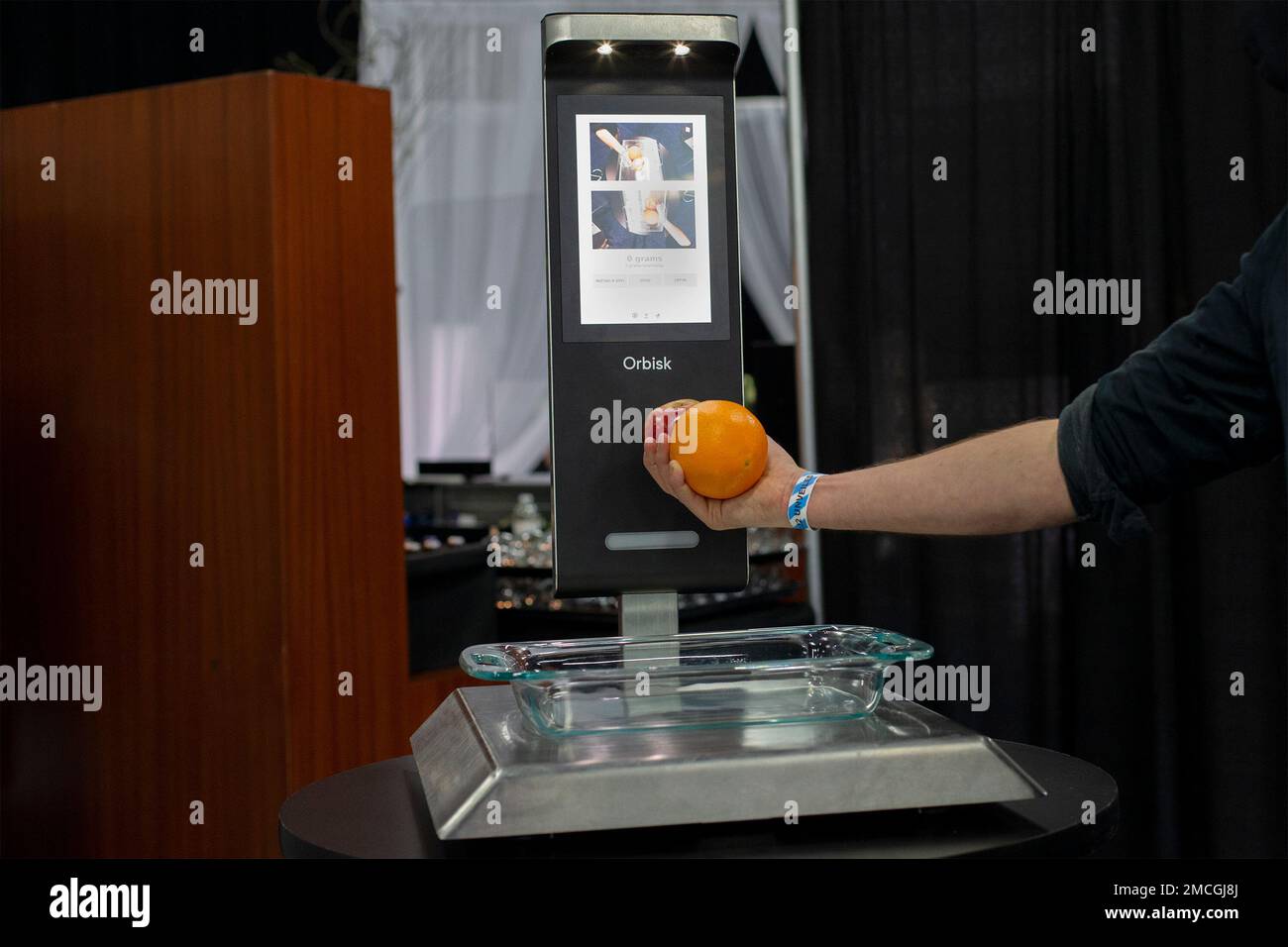 Exhibitor Olaf van der Veen demonstrates how Orbisk measures food ...