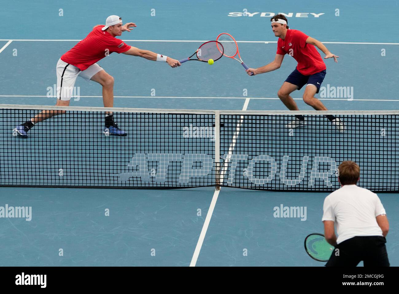 United States' Taylor Fritz and teammate John Isner, left, return a ...