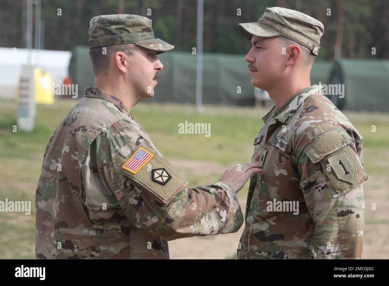 U.S. Army Staff Sgt. Ricky Cooksey, pins the rank of sergeant on U.S ...