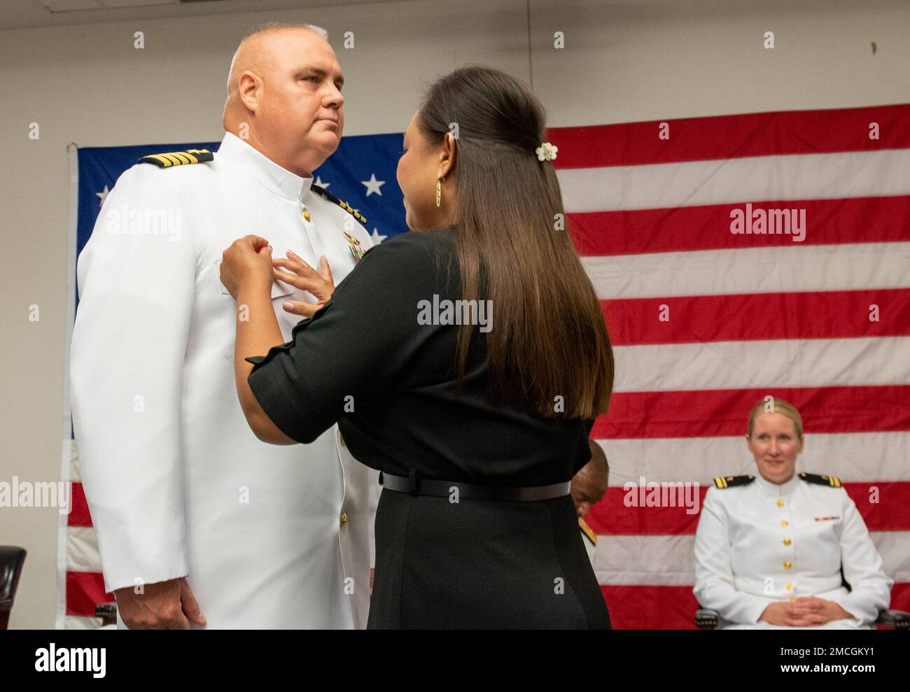Capt Ty Jurica has his Command pin affixed by his wife Joanne Stock ...
