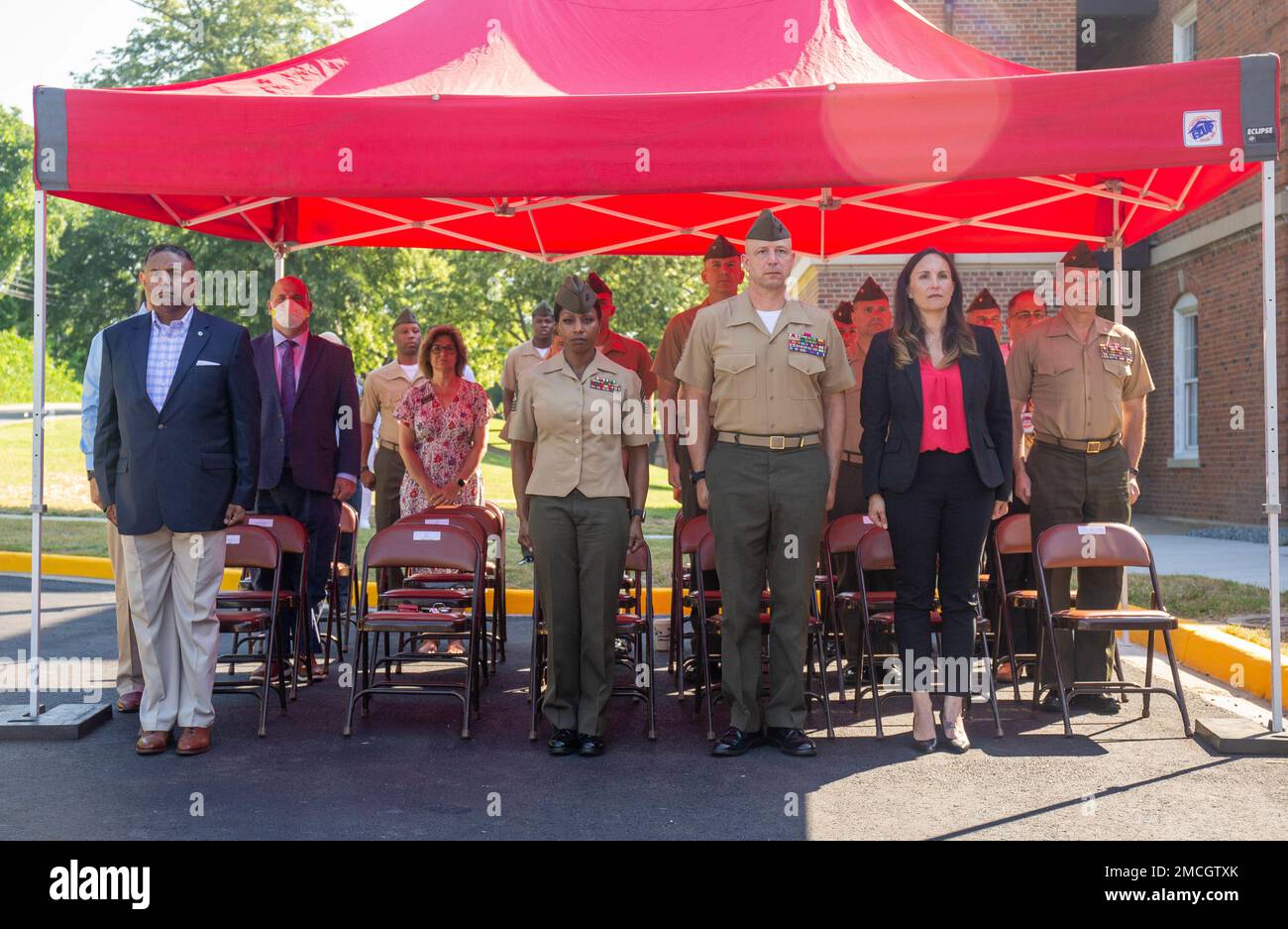 U.S. Marines, DoD civilians, retirees, and guests take part in a ribbon ...