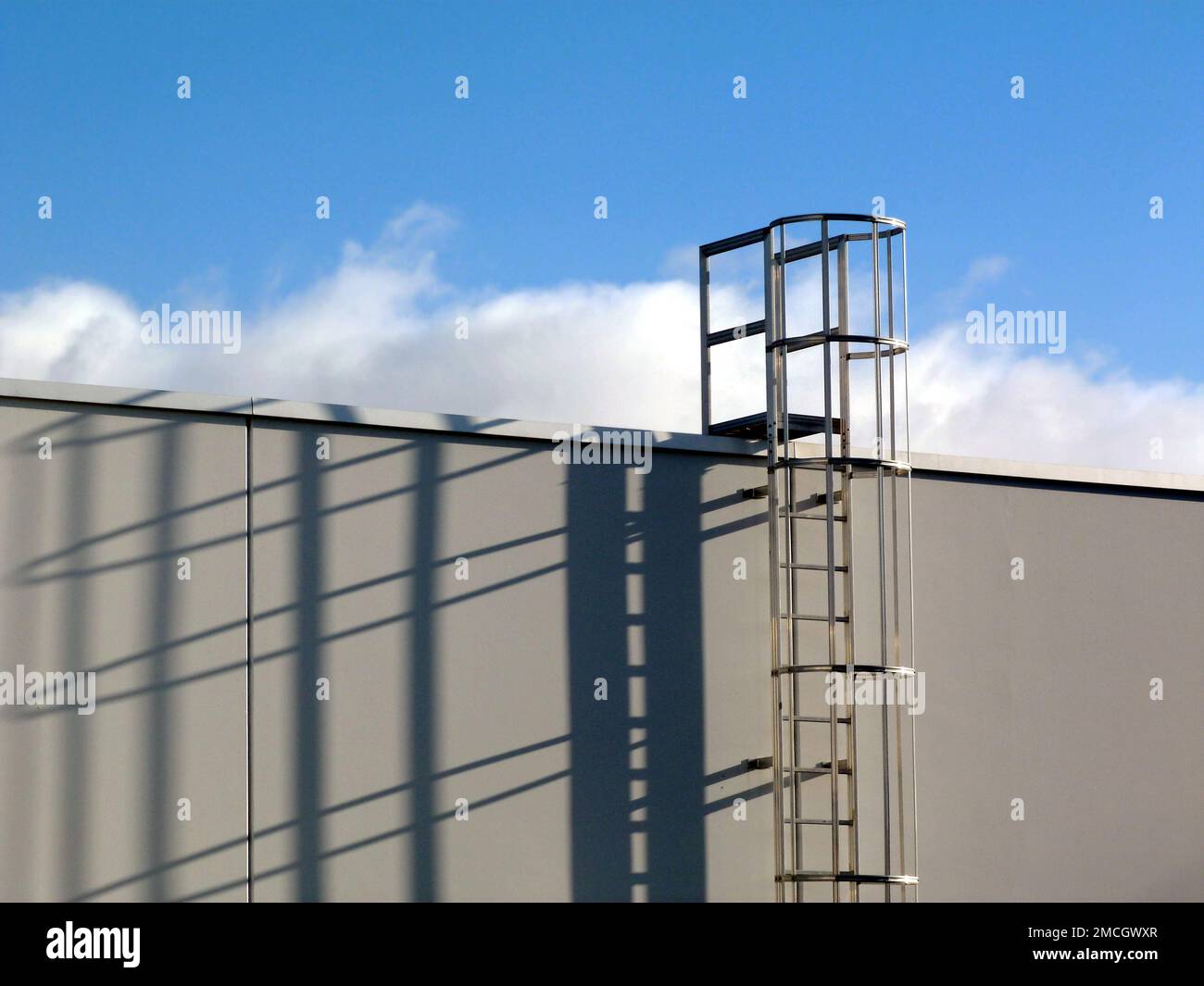 aluminum roof access ladder detail with safety cage. bolted to white ...