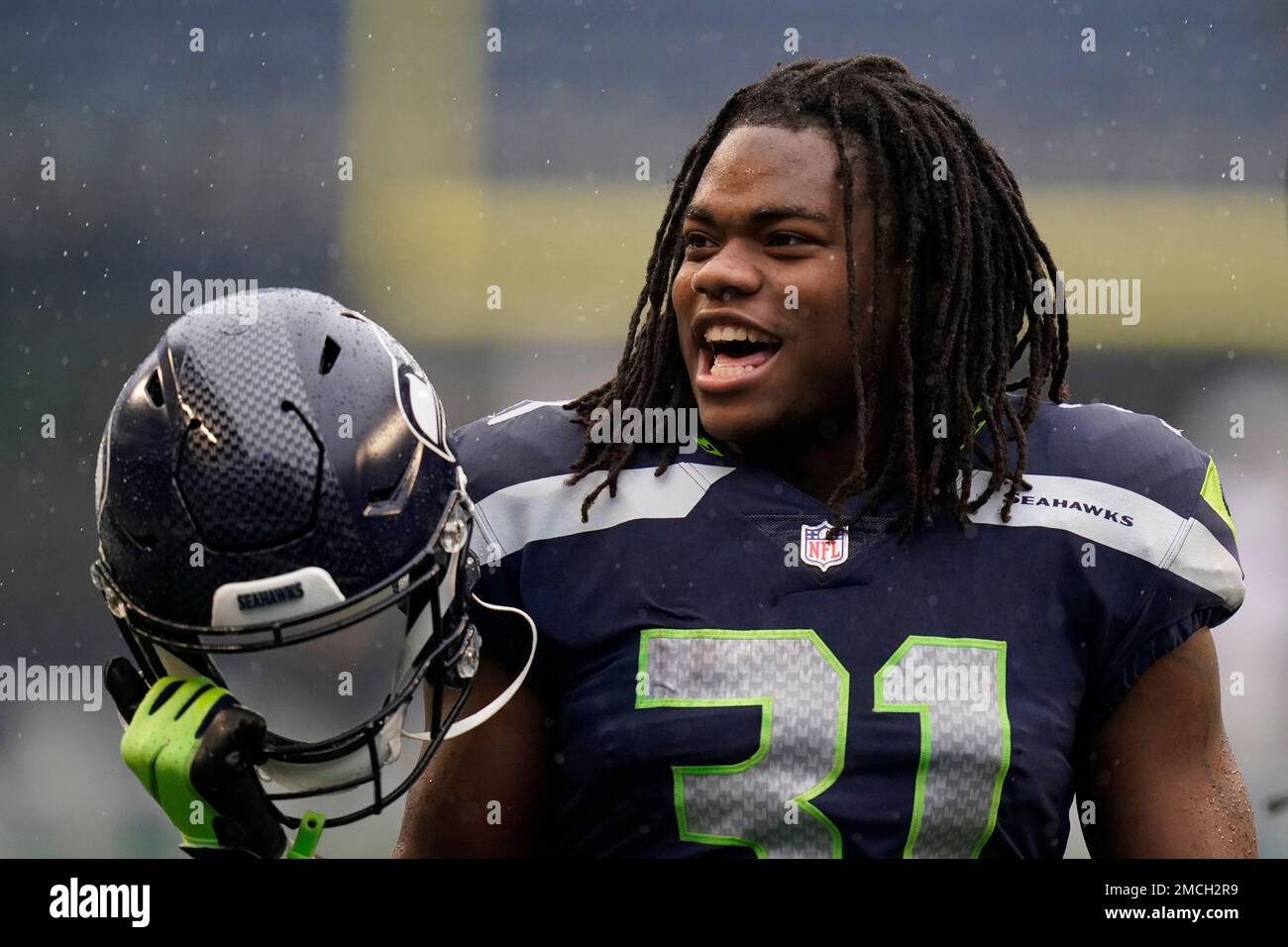 Seattle Seahawks running back DeeJay Dallas holds his helmet before an ...