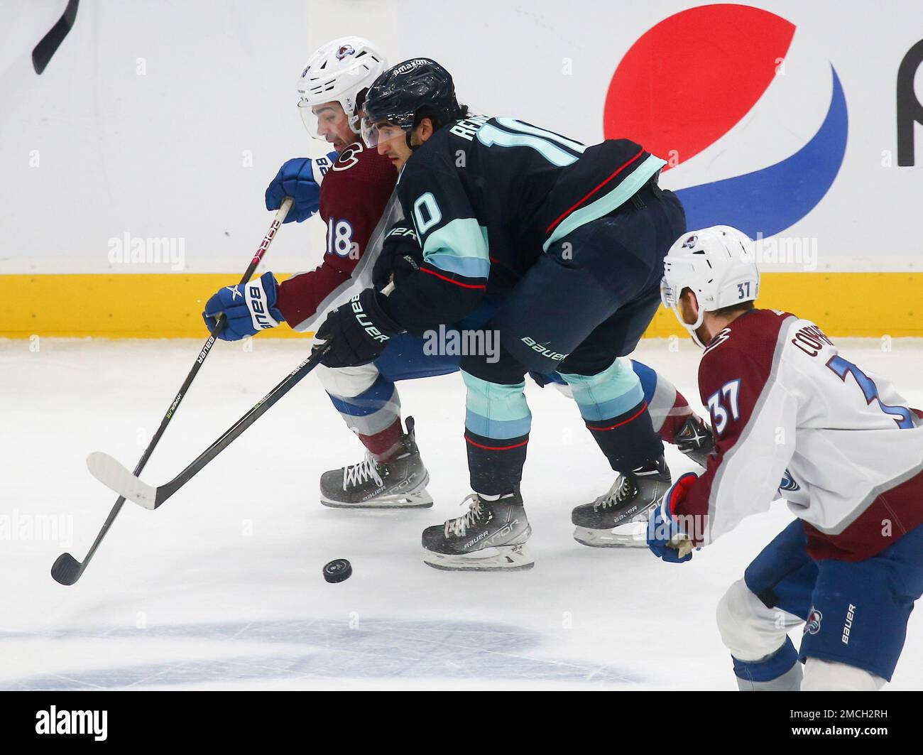 Colorado Avalanche center Alex Newhook (18) and Seattle Kraken center ...