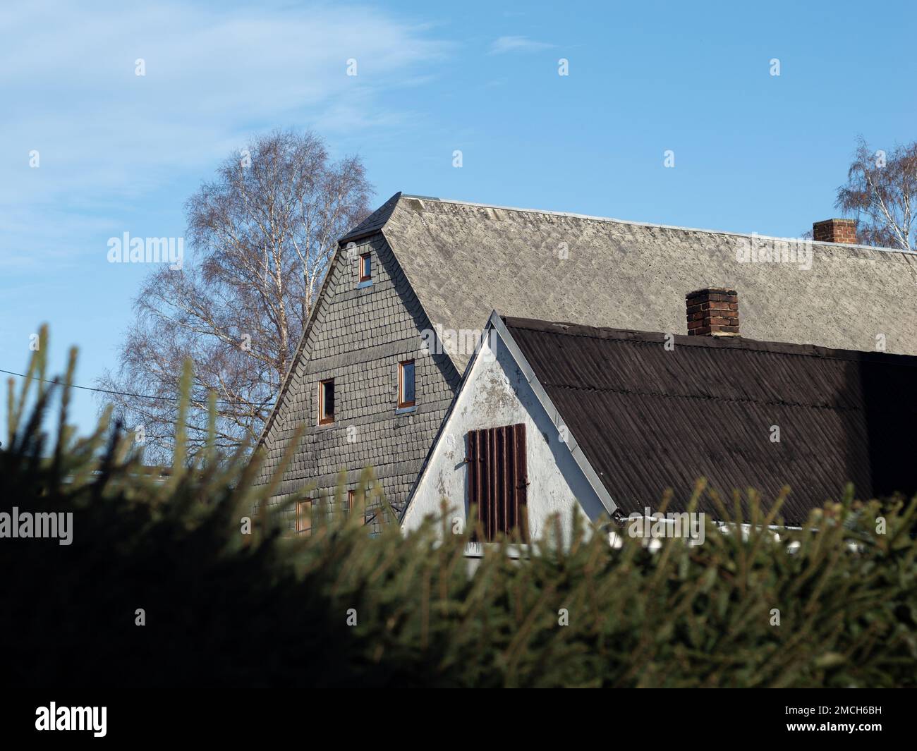 Old house with asbestos sheets on the exterior wall and on the roof ...