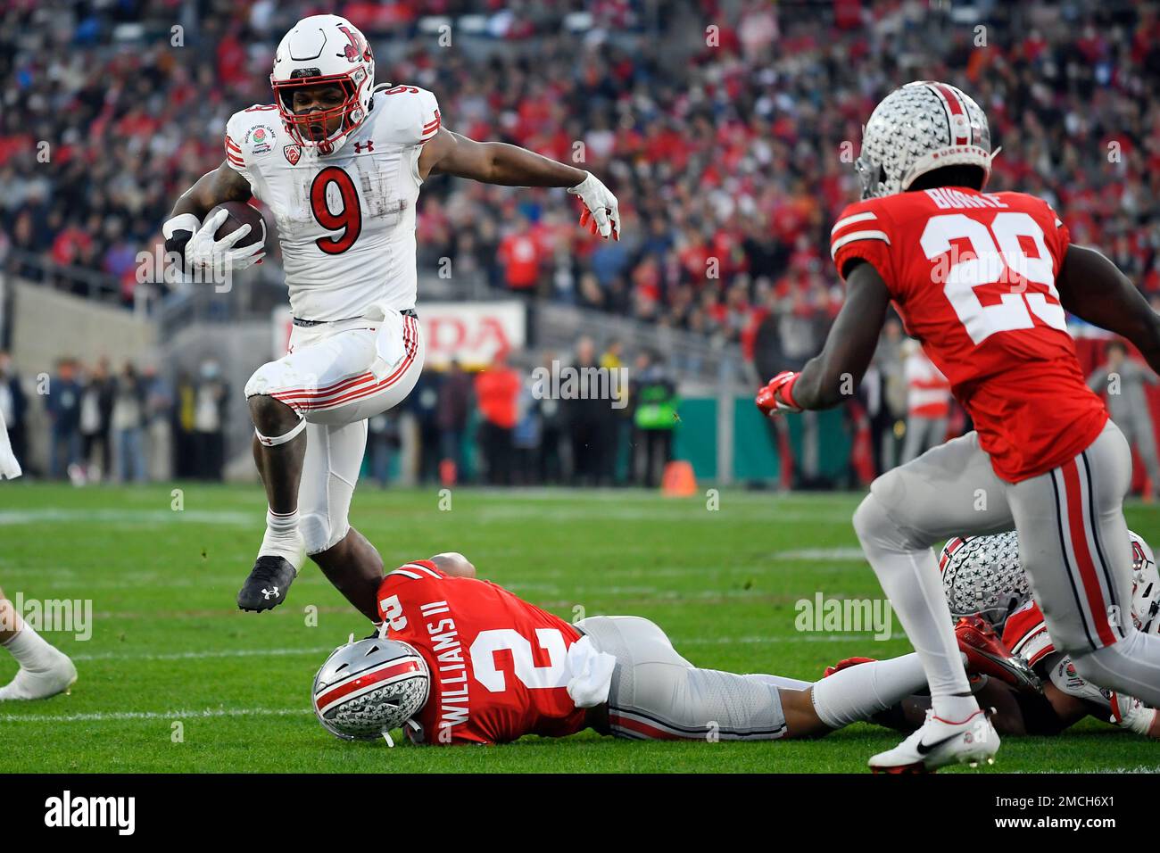 Utah running back Tavion Thomas (9) jumps over Ohio State safety Kourt ...