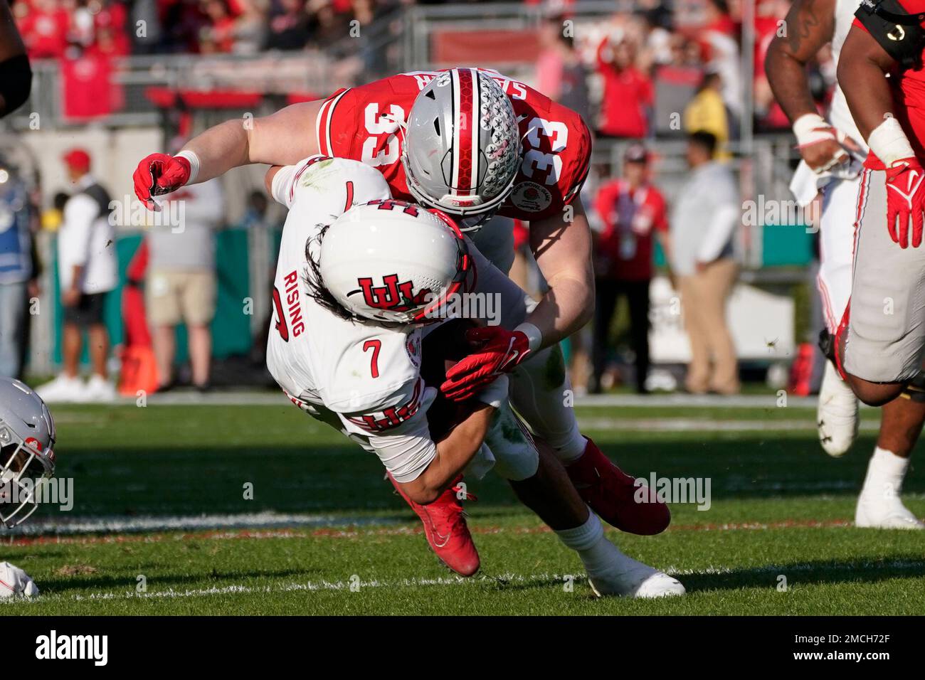 Utah quarterback Cameron Rising (7) is hit by Ohio State defensive end ...