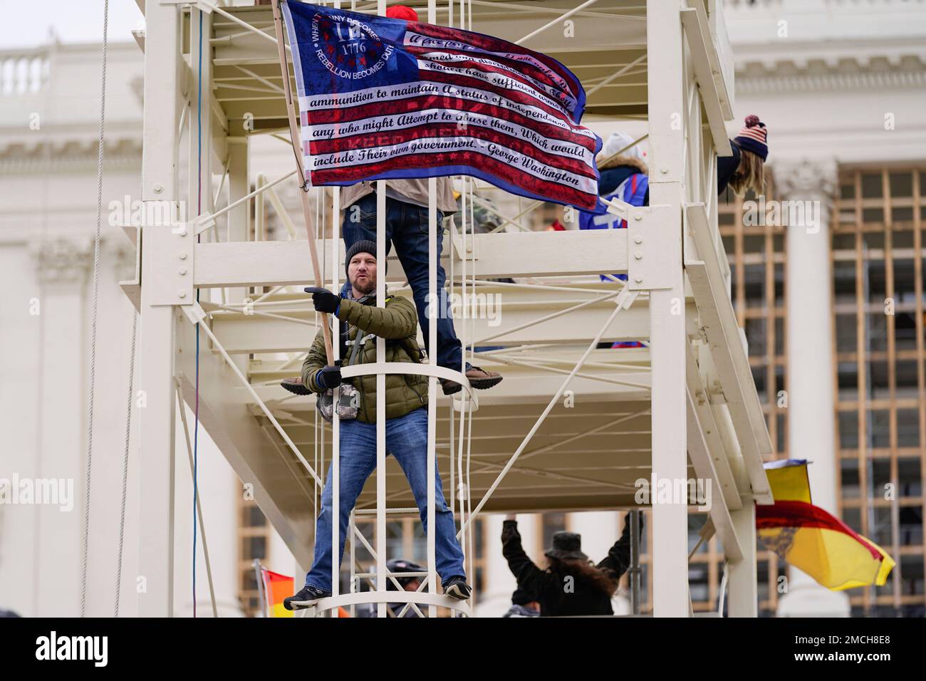Rioters who support President Donald Trump wave a flag at the U.S ...