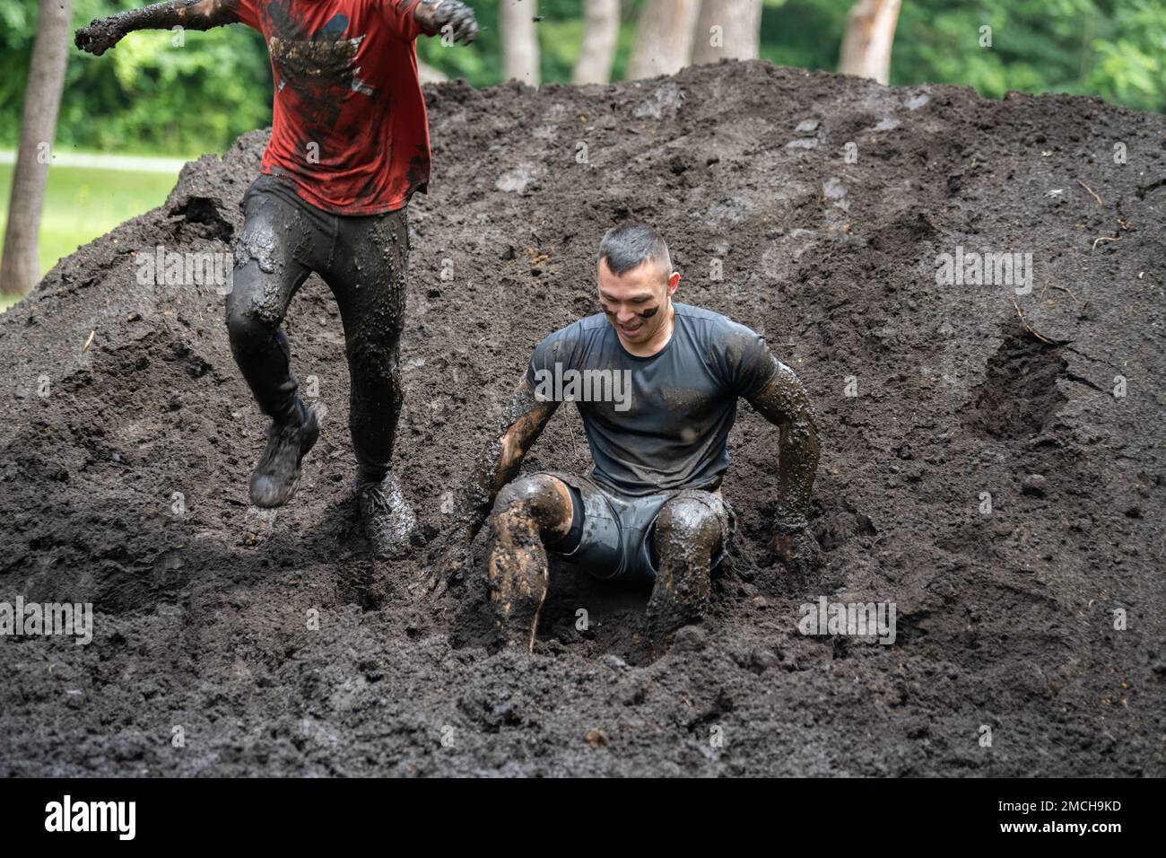 A participant attempts to get out of the second obstacle during the ...
