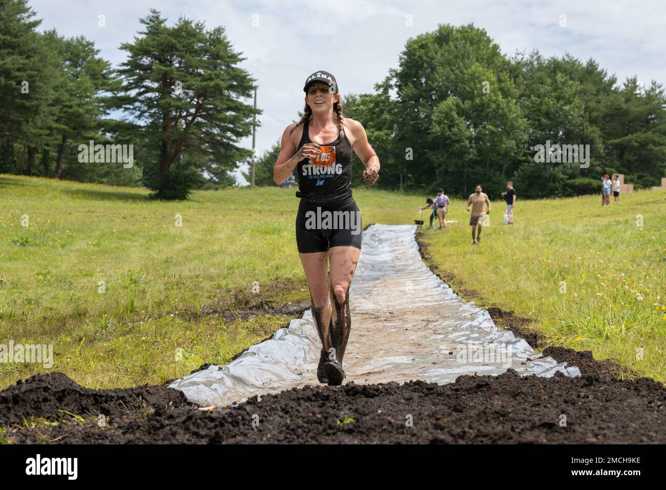 A participant runs through a mud pit during the annual Misawa Mudder at ...