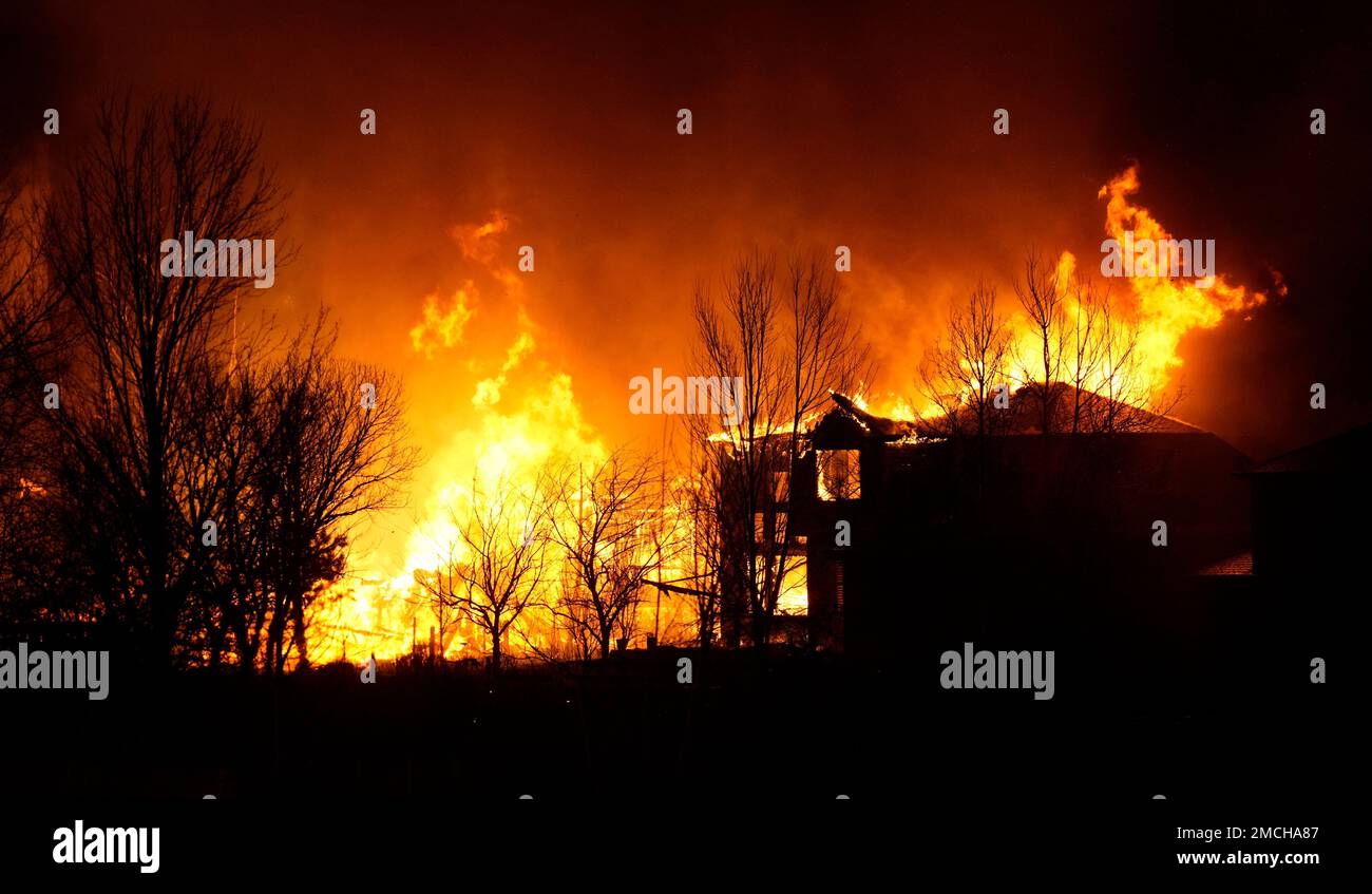 Homes burn as wildfires rip through a housing development Thursday, Dec ...