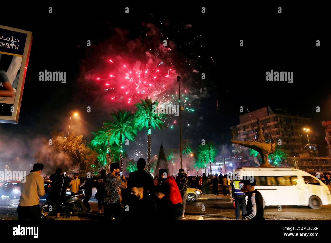 People watch fireworks explode during New Year celebrations in Baghdad ...