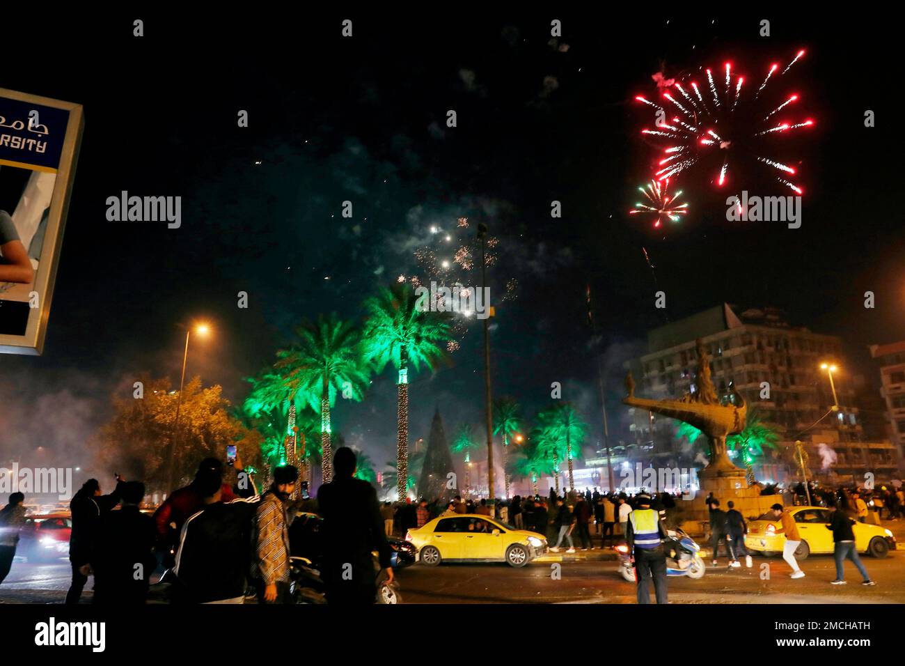 People watch fireworks explode during the New Year celebrations in ...