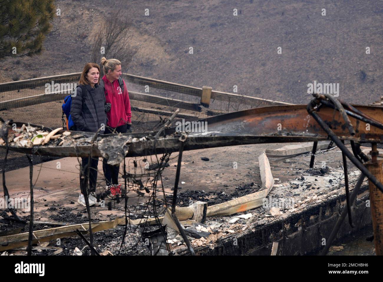 Cathy Glaab, left, surveys what's left of her home, accompanied by her ...