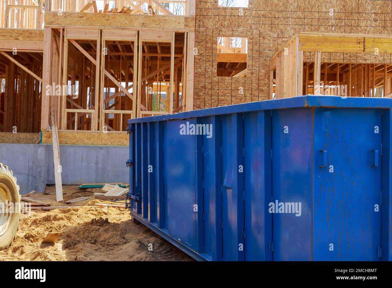 Construction site a rubbish removal container on house underneath an ...