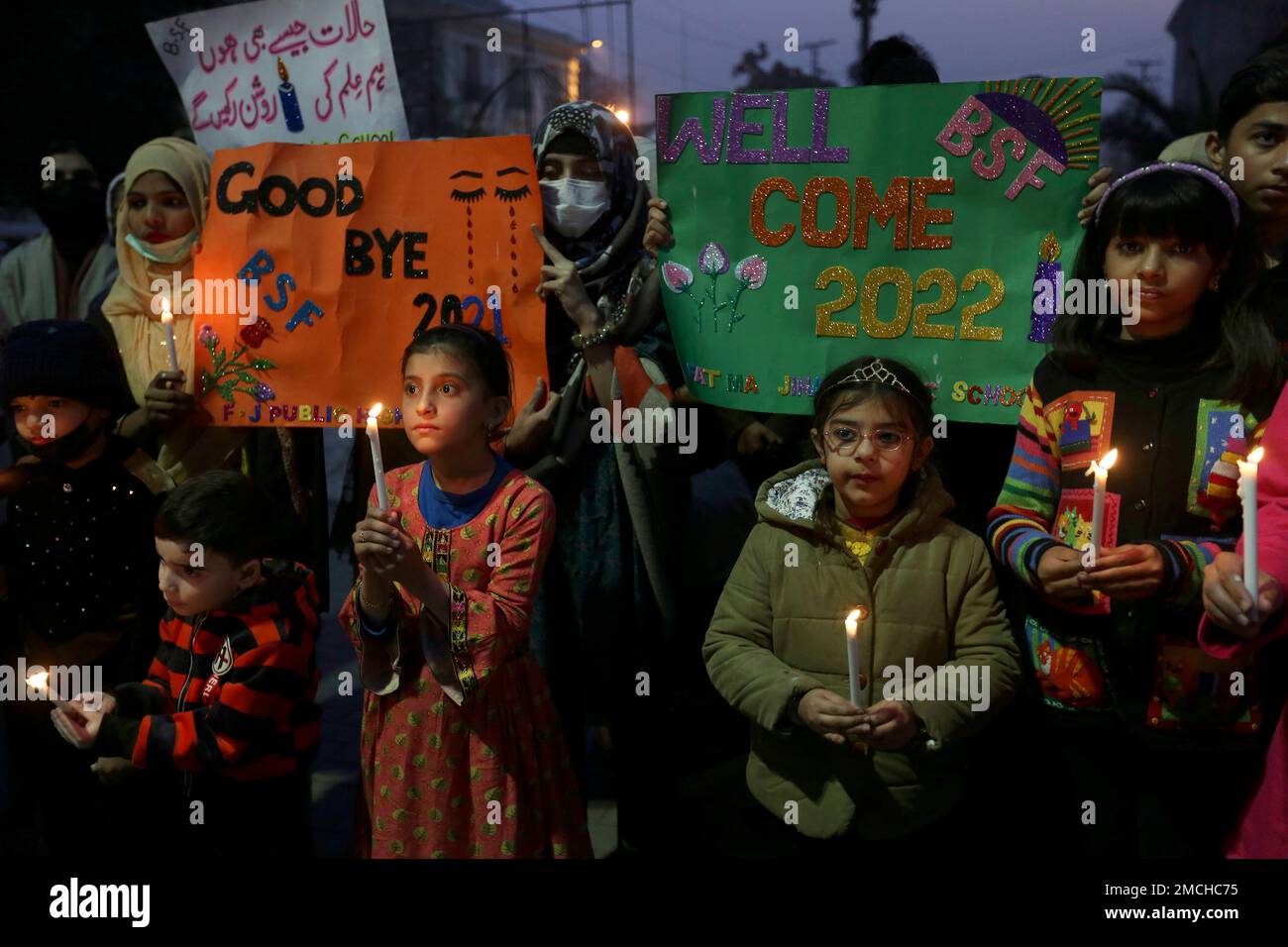 Students holds candles while participating in a demonstration to say ...