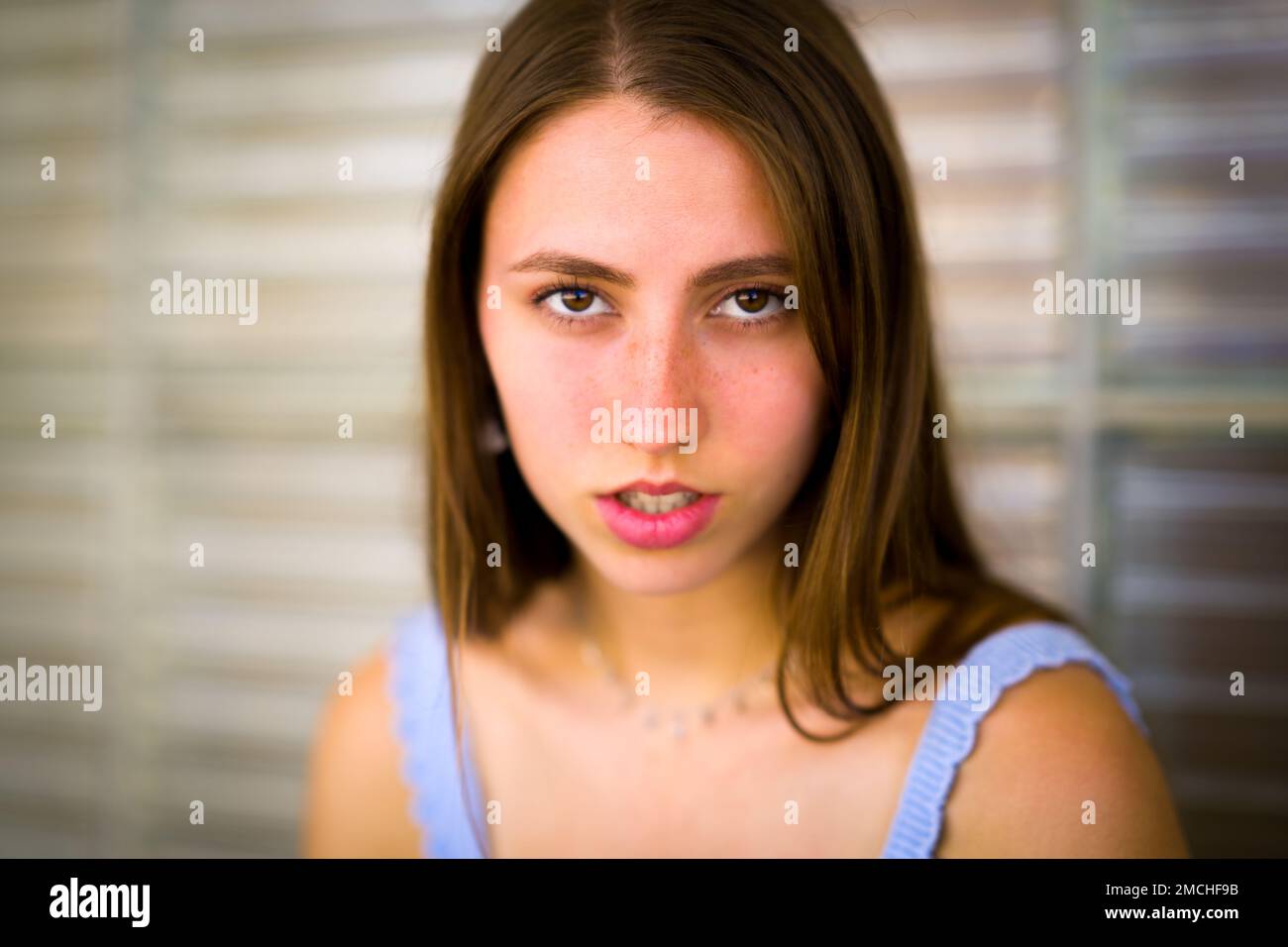 Close up Portrait of Teenage Girl Leaning Against Art Deco Glass Brick ...