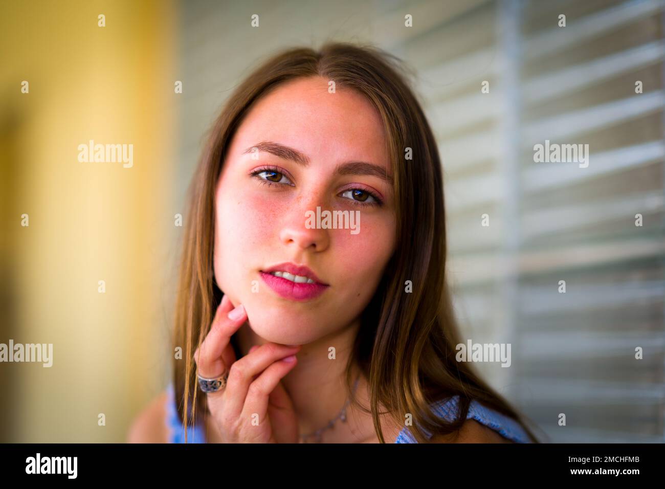 Close up Portrait of Teenage Girl Leaning Against Art Deco Glass Brick ...