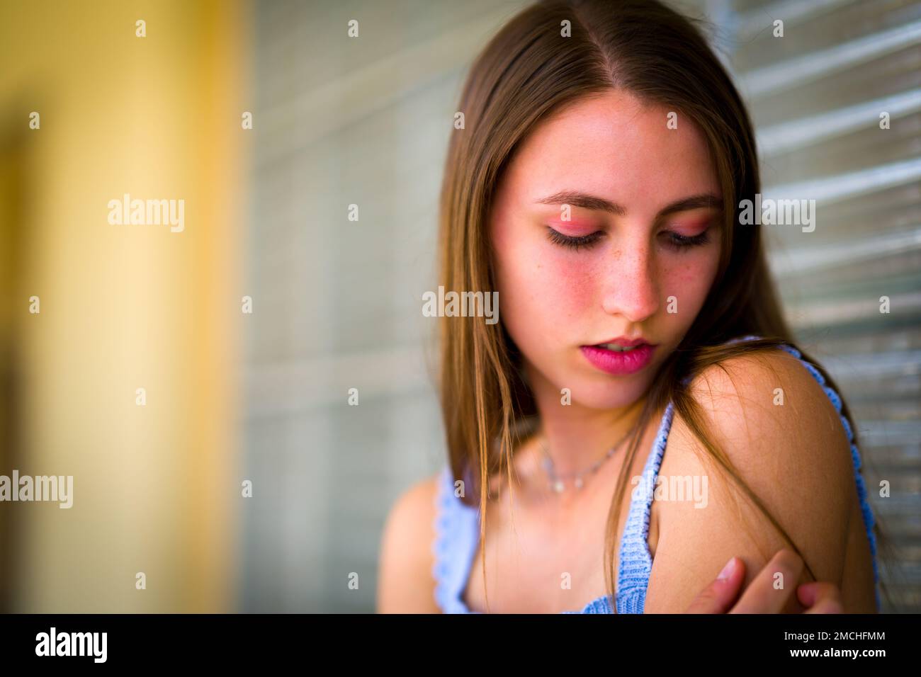 Close up Portrait of Teenage Girl Leaning Against Art Deco Glass Brick ...