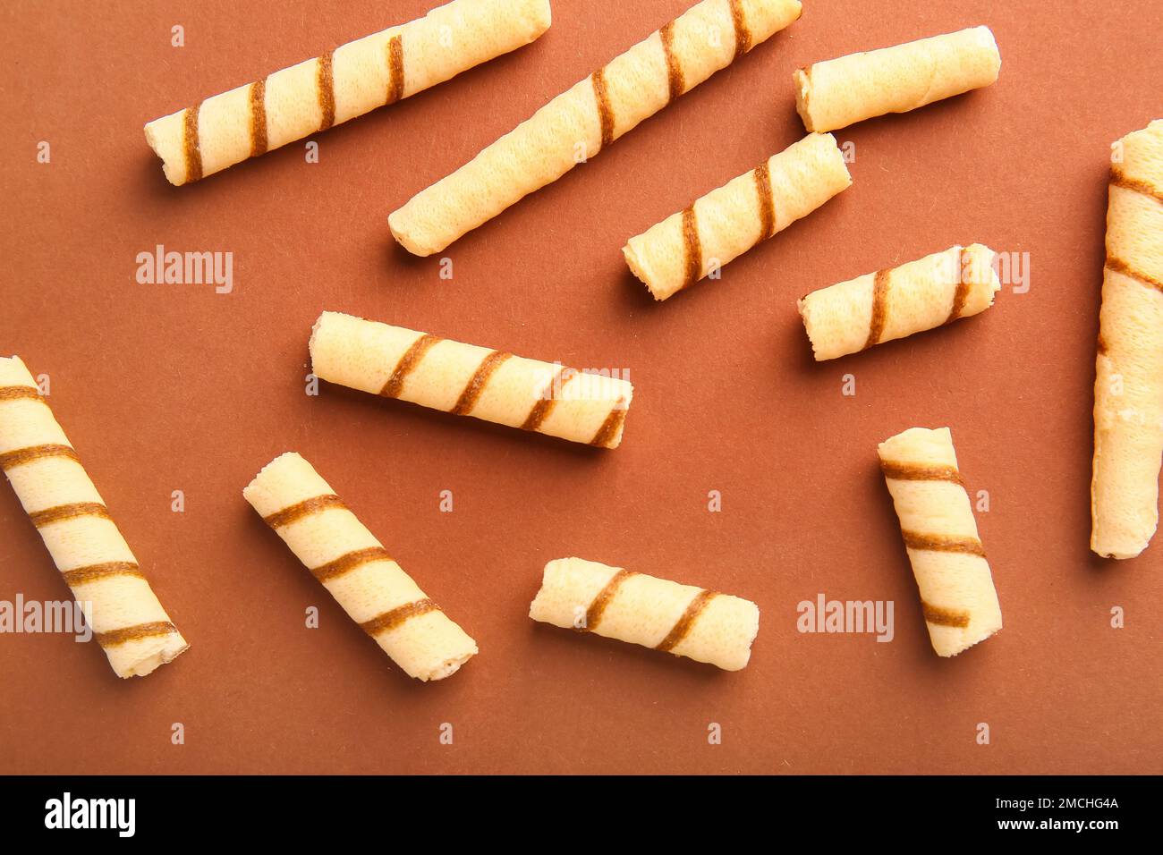 Tasty wafer rolls on brown background Stock Photo - Alamy