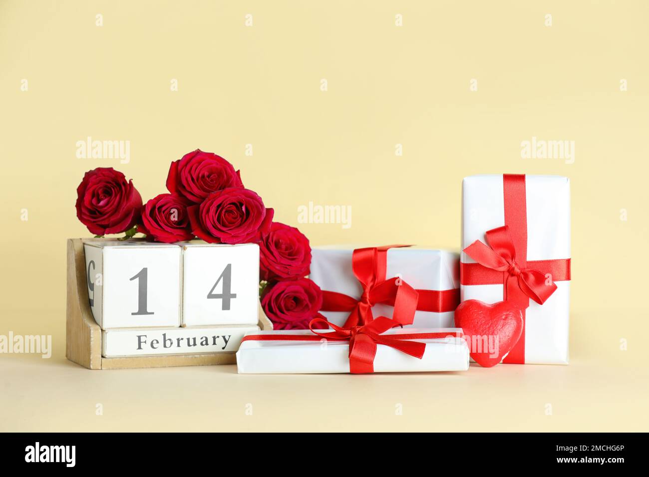 Gift boxes, rose flowers and cube calendar with date 14 FEBRUARY on ...
