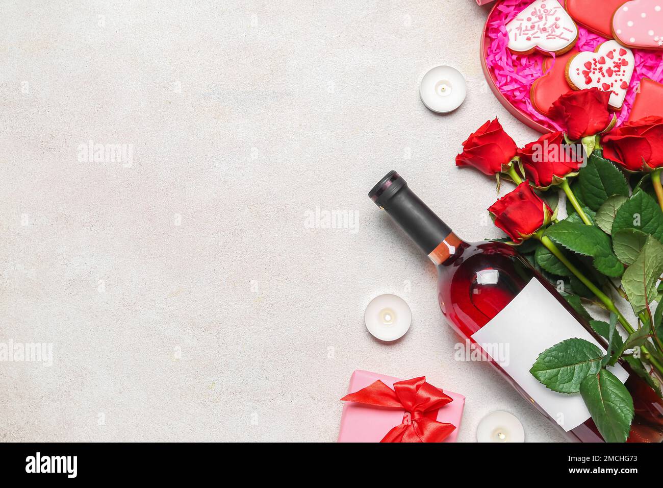 Bottle of wine, rose flowers, gift box and heart-shaped cookies on ...