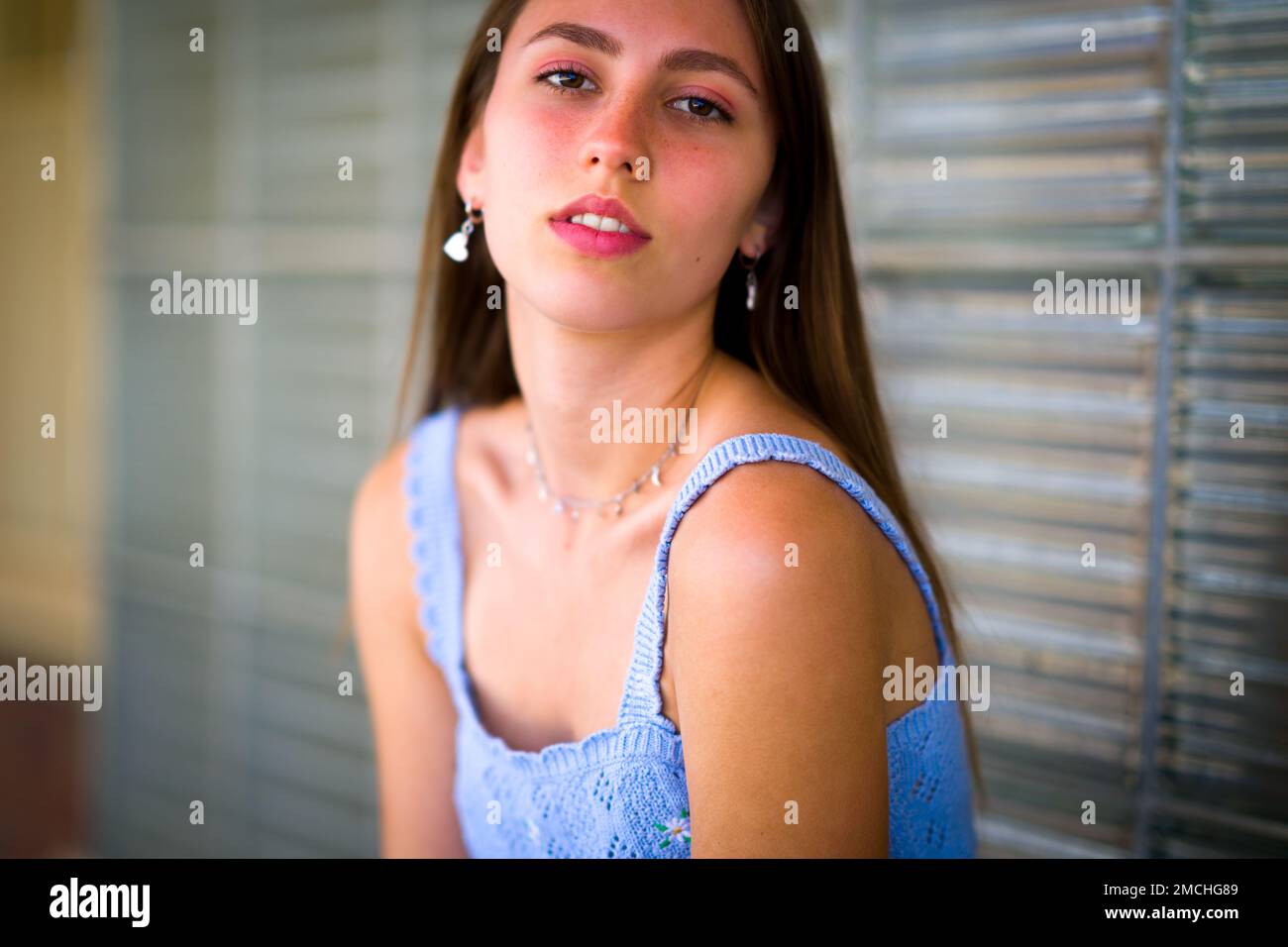 Close up Portrait of Teenage Girl Leaning Against Art Deco Glass Brick ...