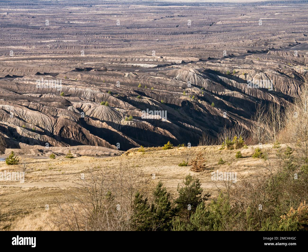 Brown coal open cast mining destroys the nature. Heaped up soil in rows ...