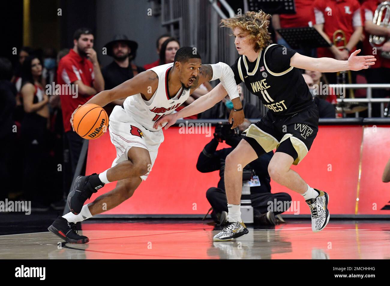 Louisville guard Mason Faulkner (11) drives past Wake Forest guard ...