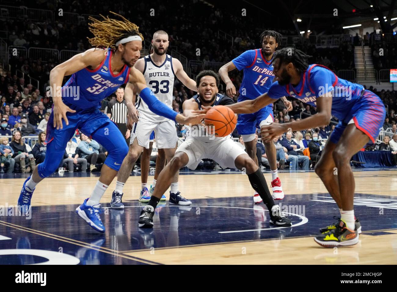 Butler forward Bryce Nze, center, goes after a loose ball against ...