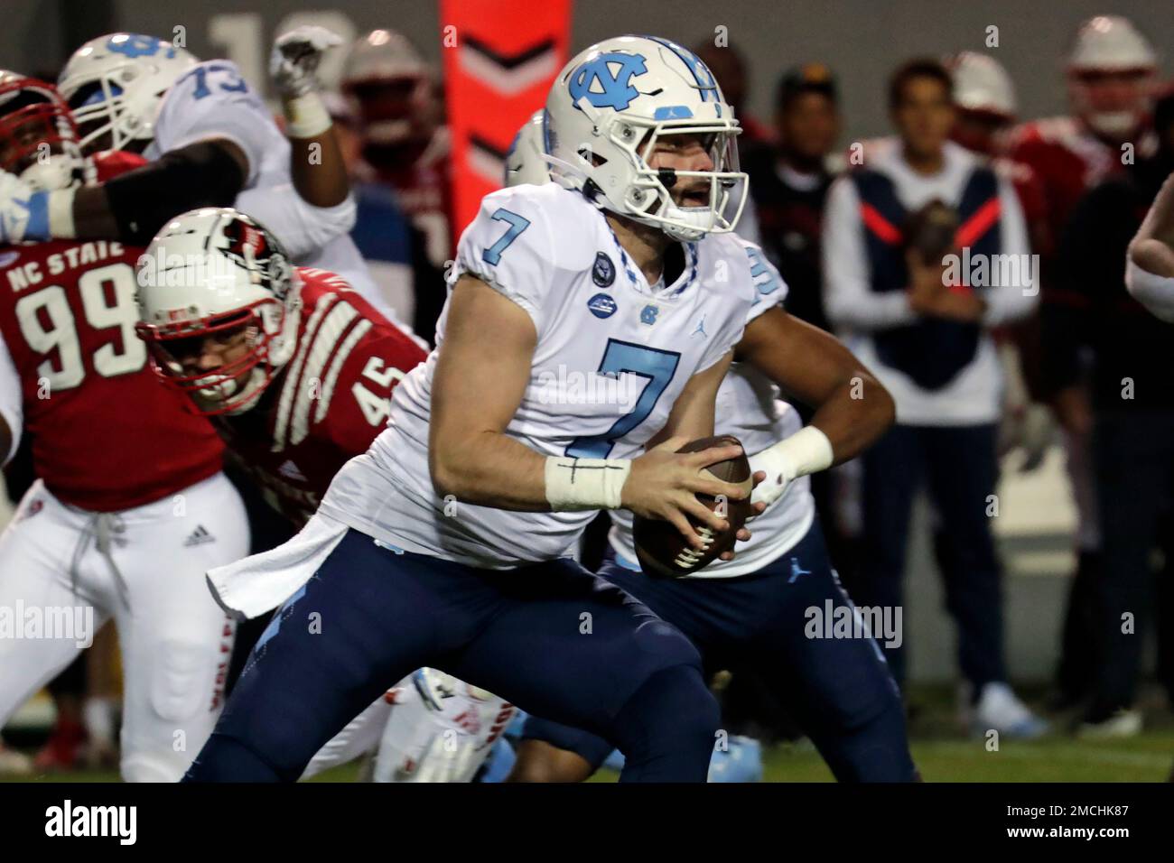 FILE - North Carolina quarterback Sam Howell (7) rolls out while being ...