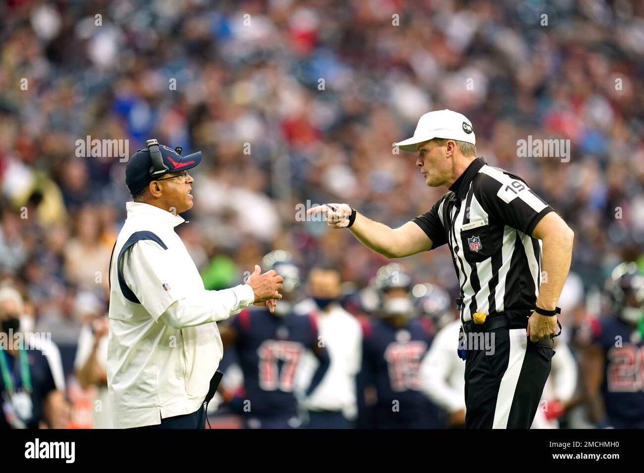 NFL official, referee Clay Martin (19) talks with Texans head coach ...