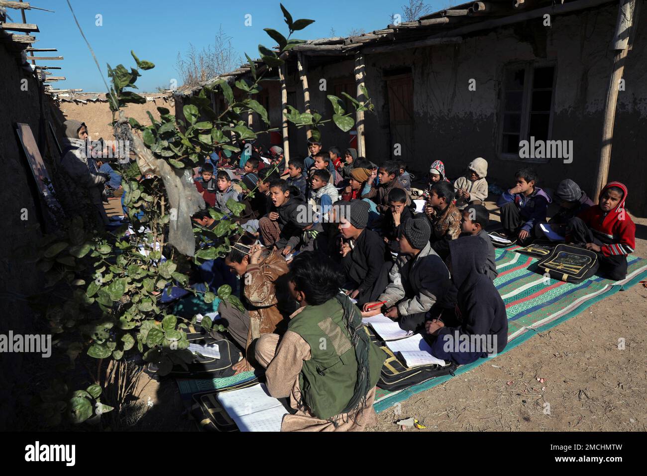 Afghan refugee schoolchildren attend a class at a makeshift school on ...