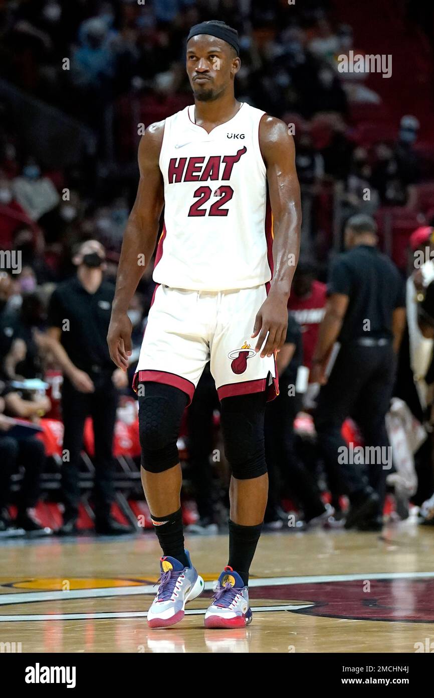Miami Heat forward Jimmy Butler (22) walks onto the court after twisting his right ankle during ...