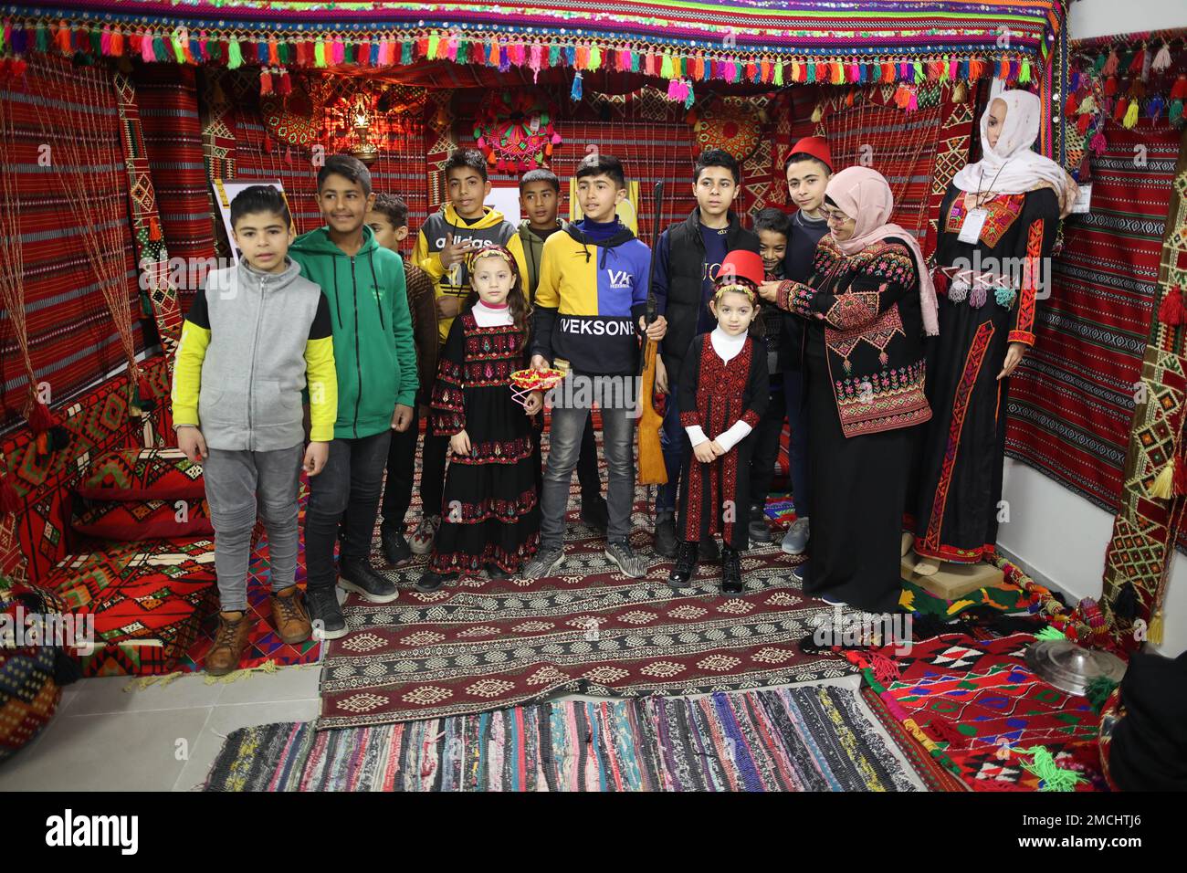Suhaila Shaheen, 60 and her visitors pose for a memory photo inside her ...