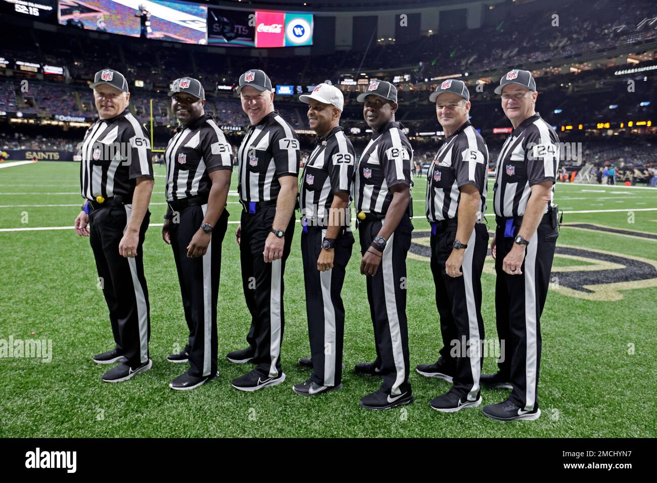 Officials, from left to right, back judge Keith Ferguson (61), field ...