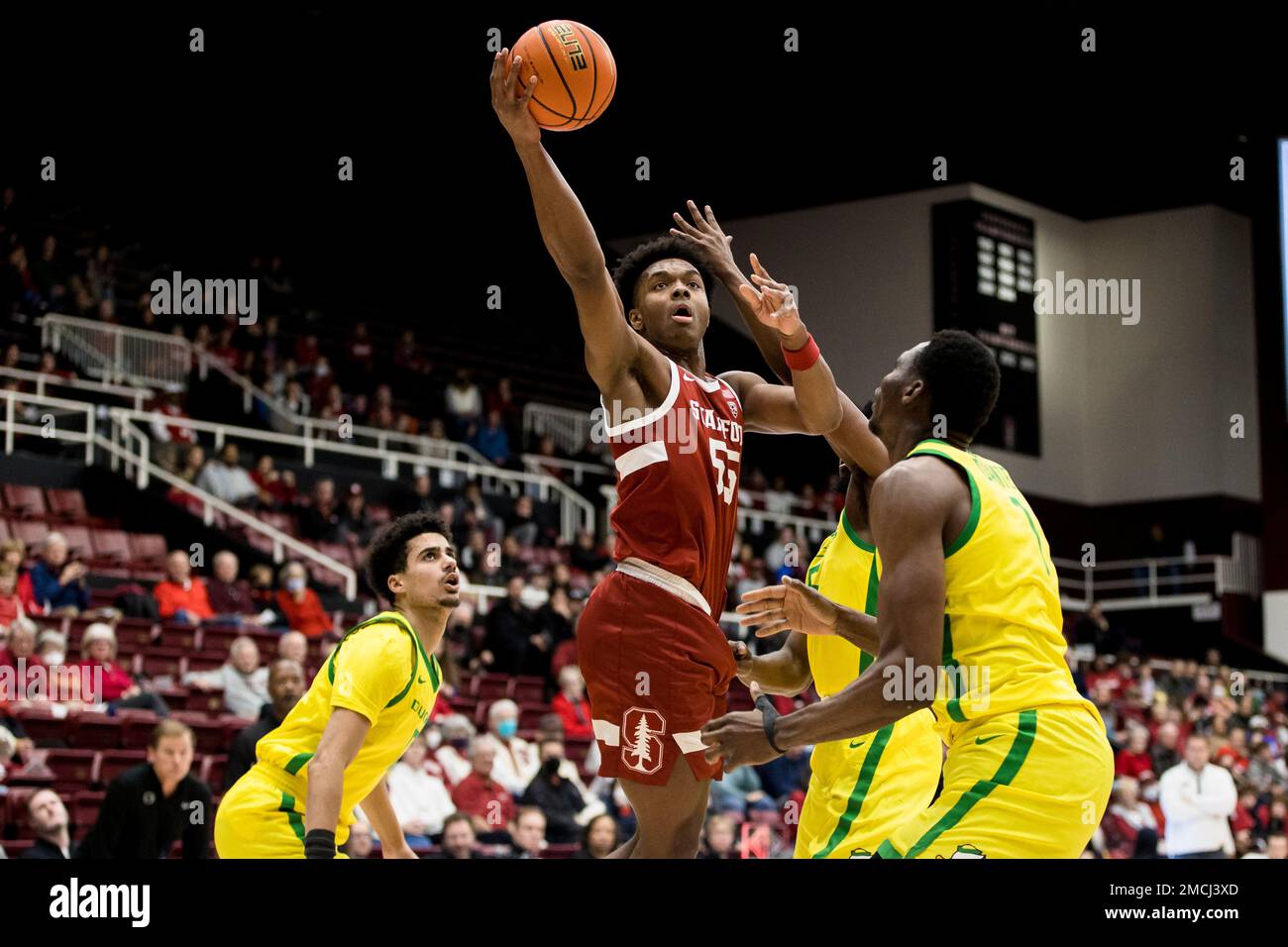 Stanford forward Harrison Ingram, center, shoots over Oregon center N ...