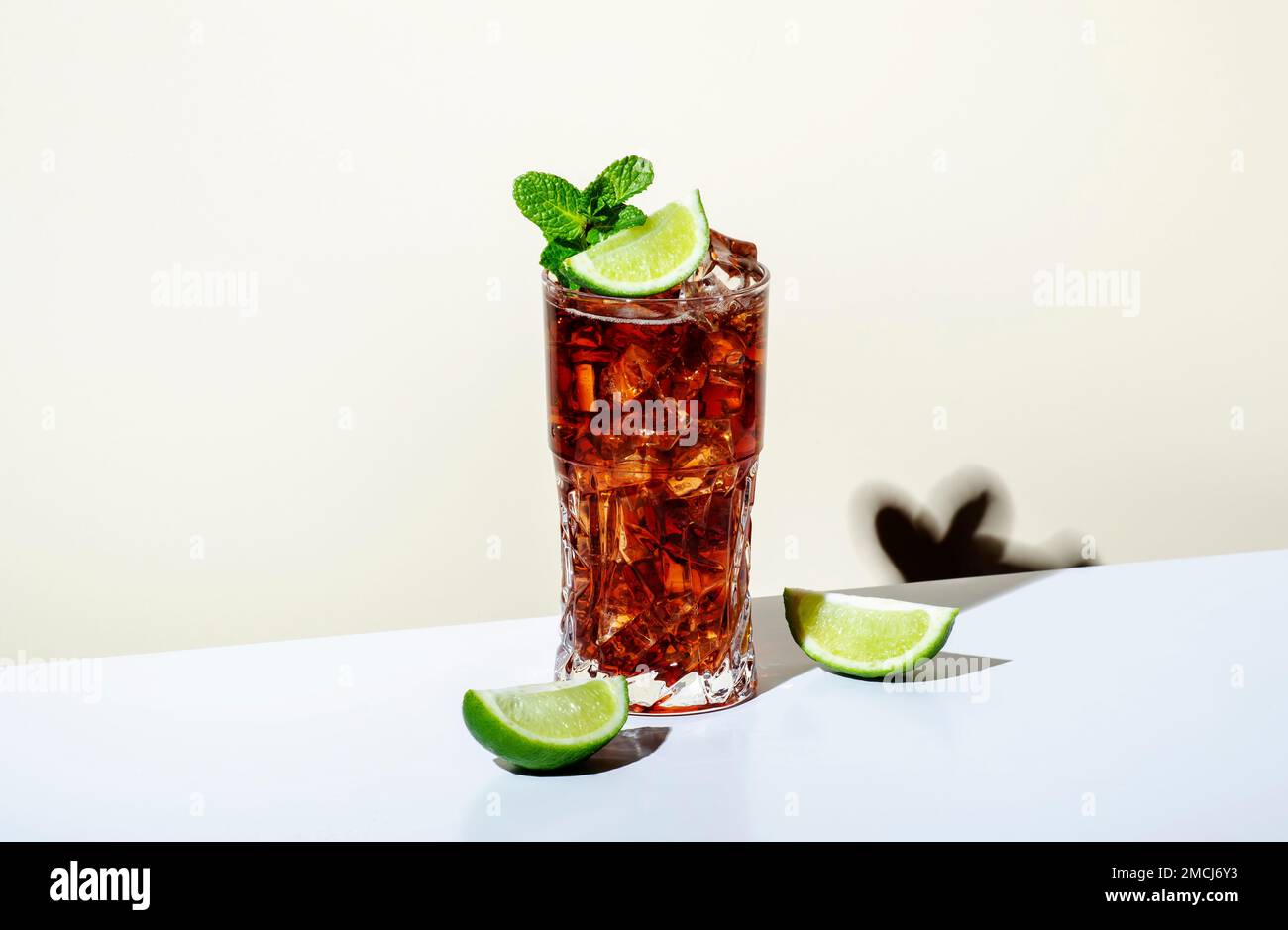 Whiskey cola cocktail with strong alcohol and ice, garnished with mint ...